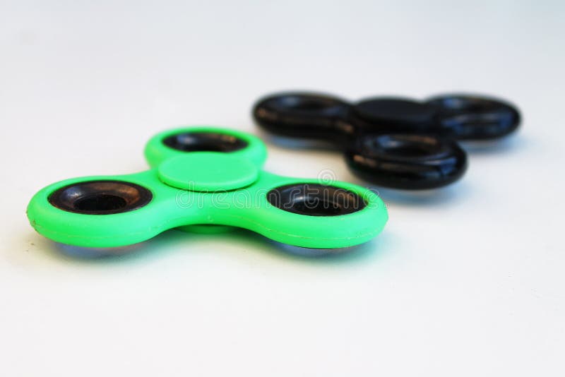 Two fidget spinners stock image. Image of green, hold - 95831997