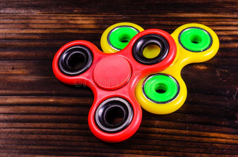 Two Fidget Spinners on Wooden Desk Stock Photo - Image of meditation ...