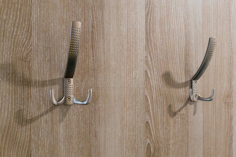 Two Figured Double Hooks on a Wooden Hanger Stock Image - Image of ...