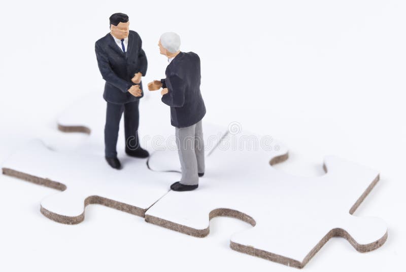 Two Figures Gives Handshake on White Puzzle Pieces Stock Photo - Image ...