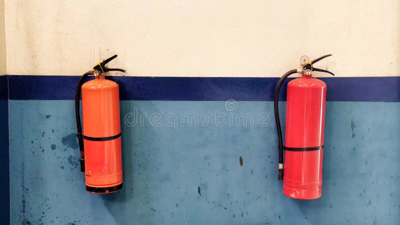 Two Fire Extinguishers Mounted on Industrial Wall for Safety Precaution ...