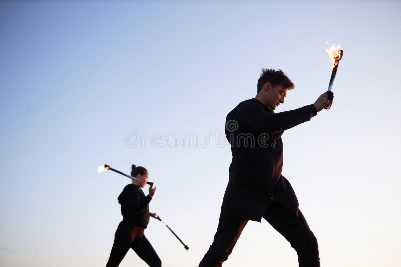 Two Fire Show Performers Dancing with Flames on Clear Sky Stock Image ...