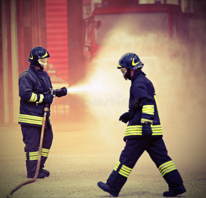 Two Firefighters during the Extinguishing of a Fire Using the Fo Stock ...