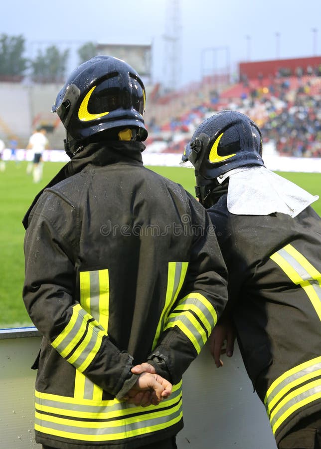 Two Firefighters with Hardhat during the Sports Event Stock Image ...