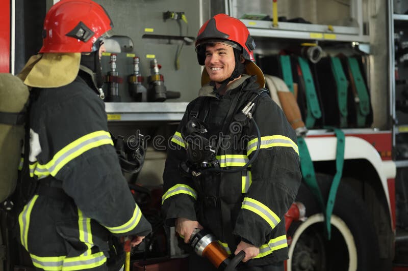 Two Firefighters in Protective Clothing in Helmets Stock Photo - Image ...