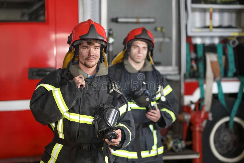 Two Firefighters in Protective Suits and Red Fire Stock Photo - Image ...