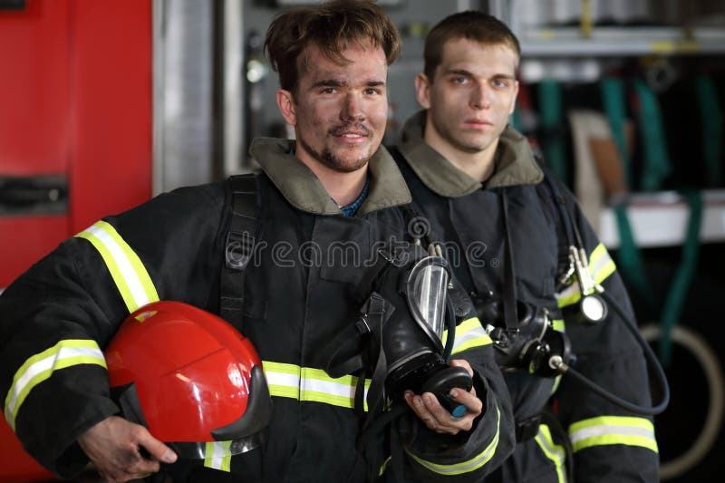 Two Firefighters in Protective Suits Standing Stock Image - Image of ...
