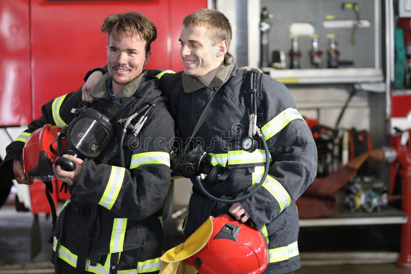 Two Firefighters in Protective Suits Standing Stock Photo - Image of ...