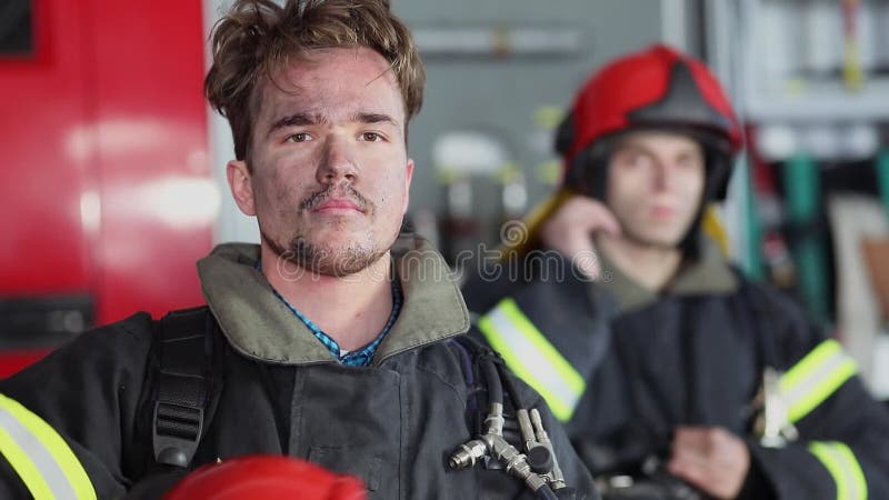 Two Firefighters in Protective Uniform Puts Off Stock Video - Video of ...