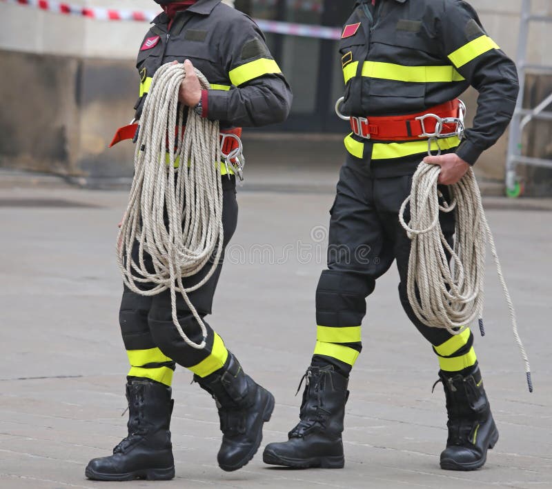 Two Firefighters with a Rope during the Rescue Operation Stock Image ...