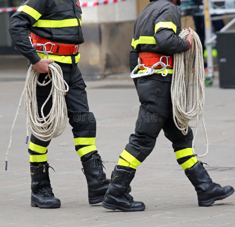 Two Firefighters with a Rope during the Rescue Operation Stock Image ...