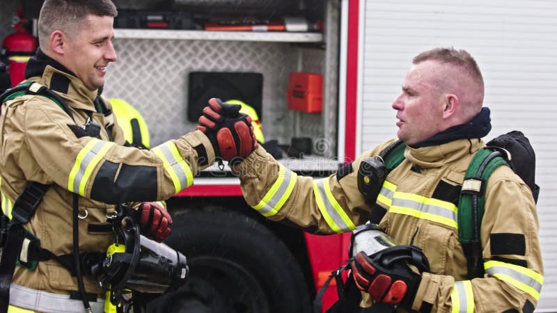 Two Firefighters Shaking Hands after Successful Fire Drill Stock ...