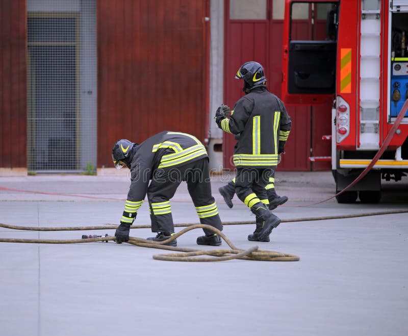 TEAM of Firefighters during the Fire Drill Mount Fast Wooden Ladder ...