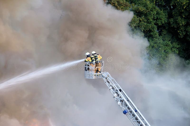 Two Firefighters Trying To Stop the Fire in the Forest Surrounded by ...