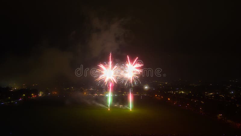 Two Fireworks Exploding Over Grassy Field at Night Stock Illustration ...