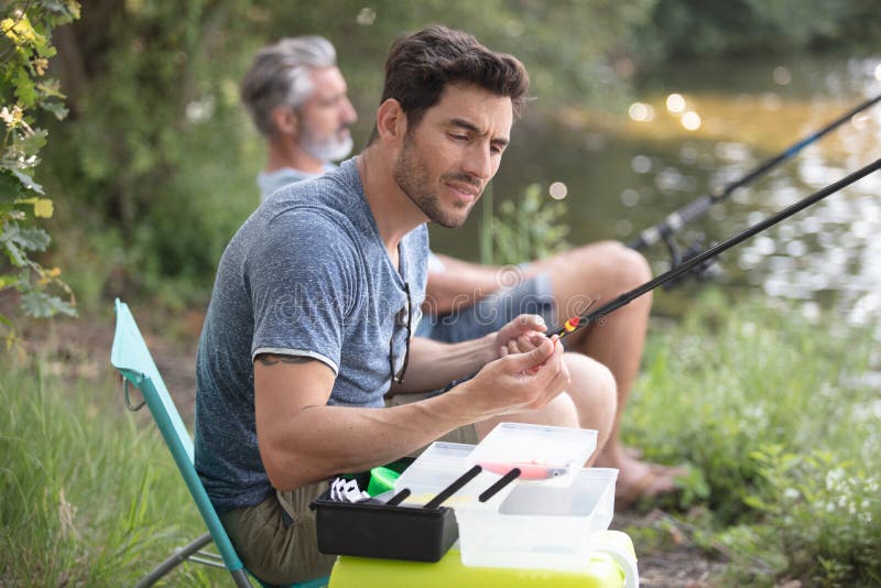 Two Fishermen with Fishing Rods on River Side Stock Photo - Image of ...