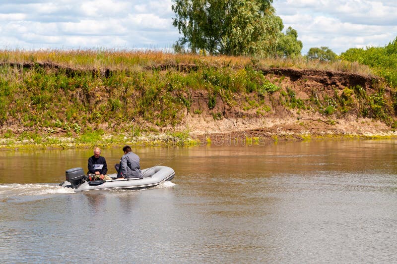Two Fishermen Float in an Inflatable Boat with an Outboard Motor on a ...