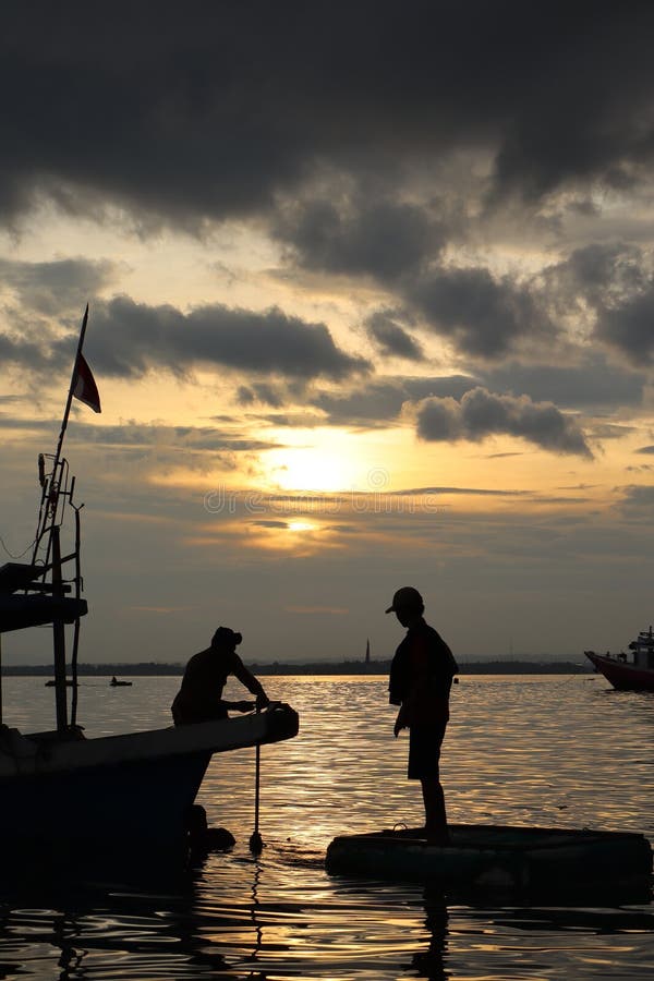 Two Fishermen Helping Each Other Stock Photo - Image of helping ...