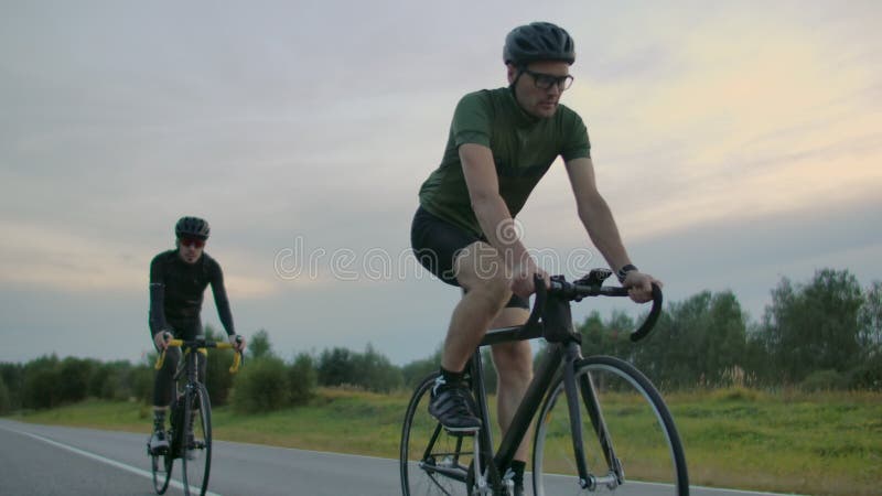 Two Fit Cyclists Race Against Each Other on the Road. Stock Footage ...