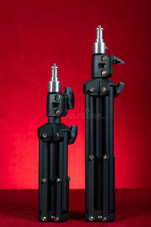 Folded Light Stands for Photography on Red Background at Vertical ...
