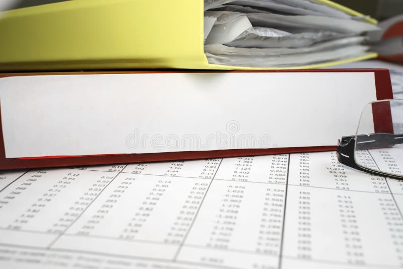 Two Folders are on Financial Documents with Columns of Numbers ...