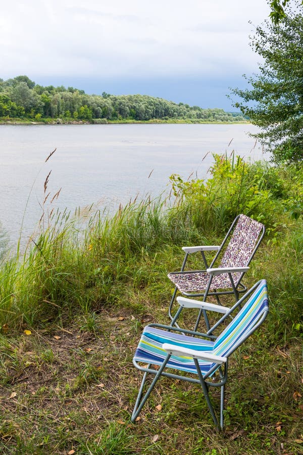 Two Folding Chairs on Nature, on the Banks of the River Stock Photo ...
