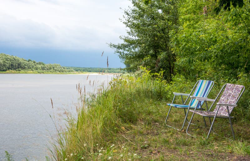 Two Folding Chairs on Nature, on the Banks of the River Stock Image ...