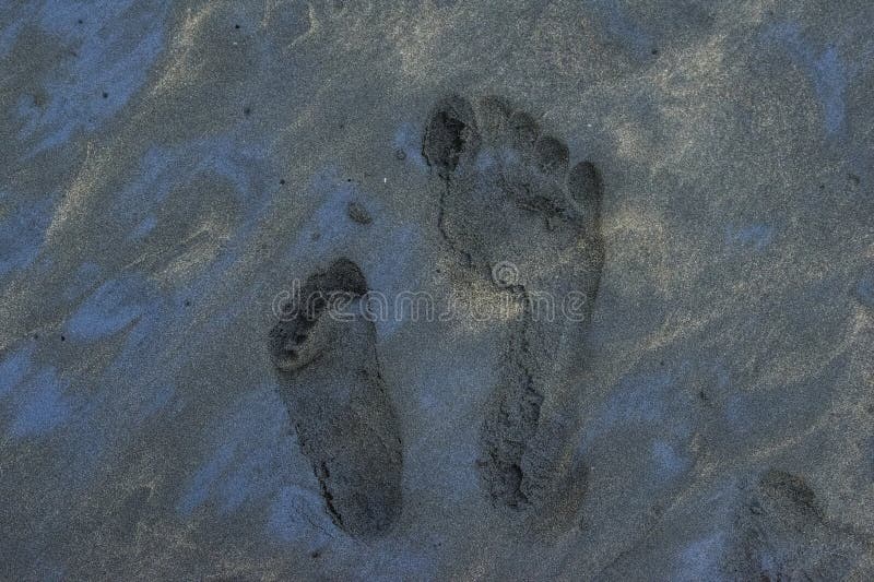Two Footprints of a Child and Mum in the Sand Stock Image - Image of ...