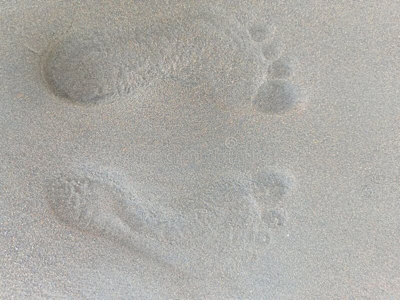 Two footprints in the sand stock photo. Image of cobblestone - 293404014