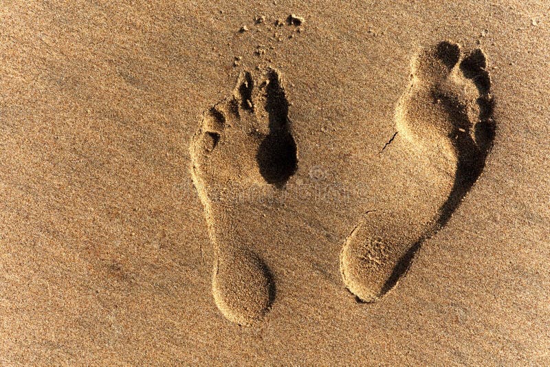 Two footprints in the sand stock photo. Image of outside - 178524098