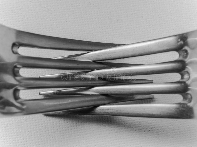 Two Forks are Crossed Over Each Other, Creating a Unique and ...