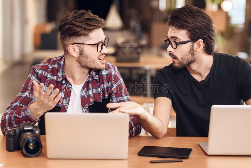 Two Freelancer Men Discussing at Laptop at Desk. Stock Photo - Image of ...
