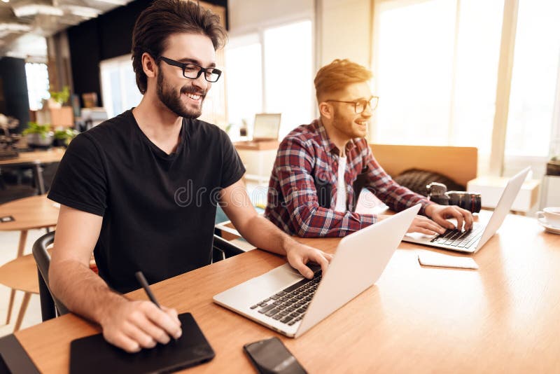 Two Freelancer Men Working at Different Laptops at Desk. Stock Photo ...