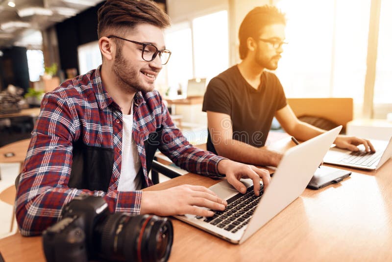 Two Freelancer Men Working at Different Laptops at Desk. Stock Photo ...