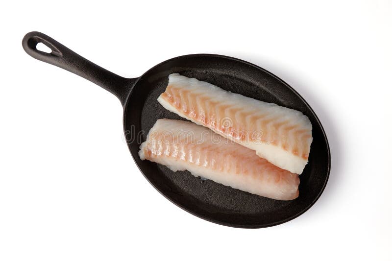 Two Fresh Cod Fish Fillets on Black Cast Iron Frying Pan Isolated on ...