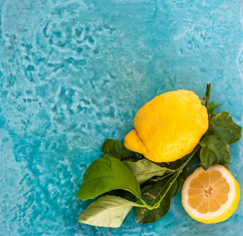 Two Fresh Lemon with Leaves on a Blue Ceramic Surface. Top View Stock ...