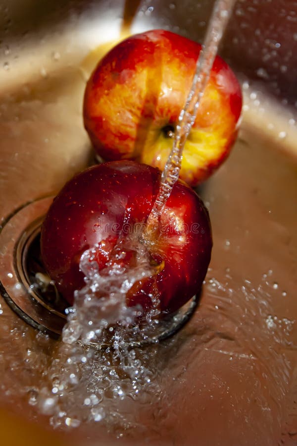 Two Fresh Red Apples Under Running Water. Apples with Drops of Water ...
