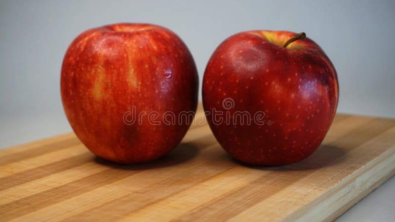 Two Fresh Red Apples on Wooden Kitchen Board Stock Image - Image of ...