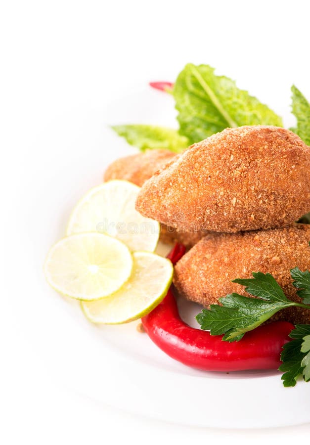Two Fried Breaded Cutlet with Vegetables and Herbs on a Plate Isolated ...