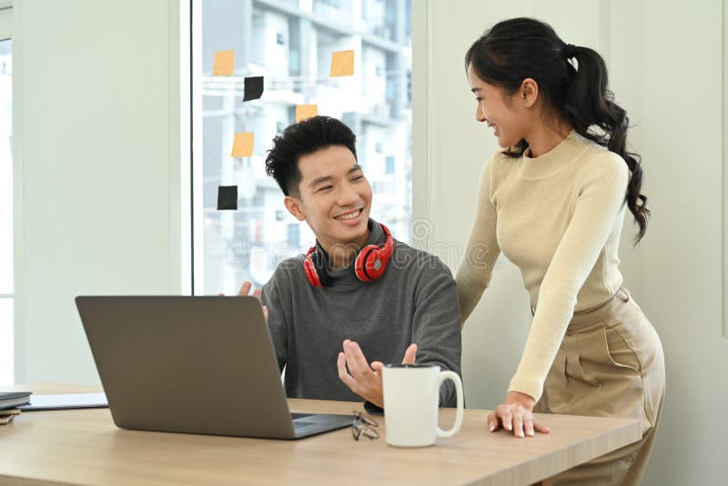 Two Friendly Creative Business People Using Laptop, Working on Social ...