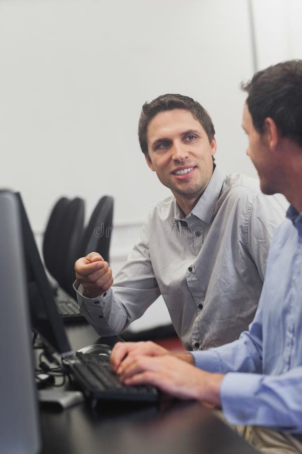 Two Friendly Men Talking Sitting in Front of a Computer Stock Photo ...