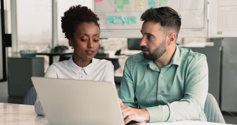 Two Friendly Multiethnic Male Female Teammates Working on Joint Task ...