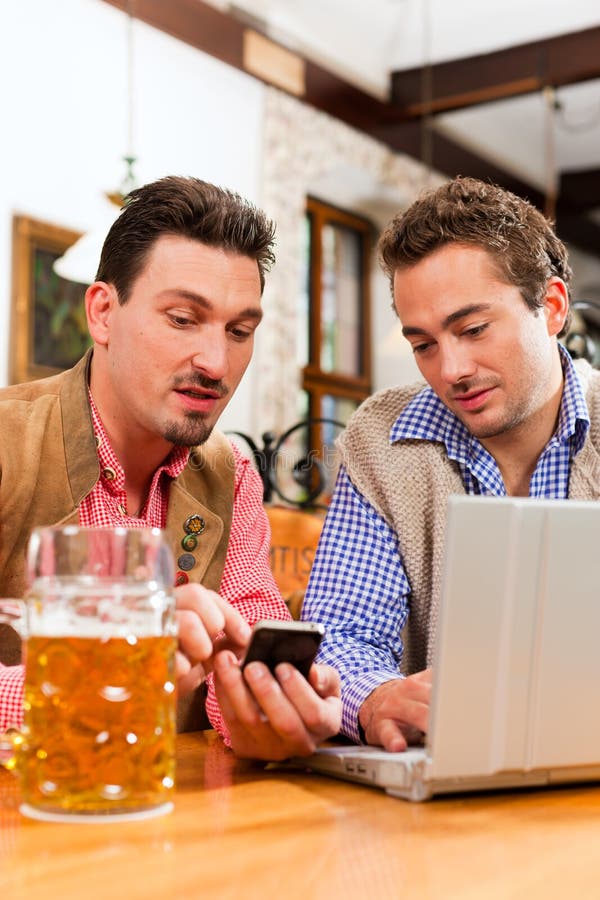 Two Friends in Bavarian Pub with Laptop Stock Image - Image of plaid ...