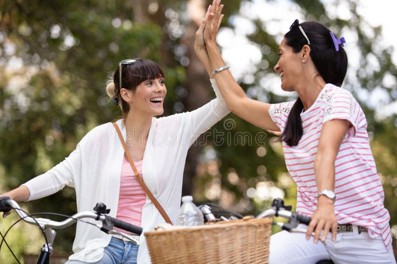 Two Friends on Bikes Outdoors Smiling Stock Photo - Image of friendship ...