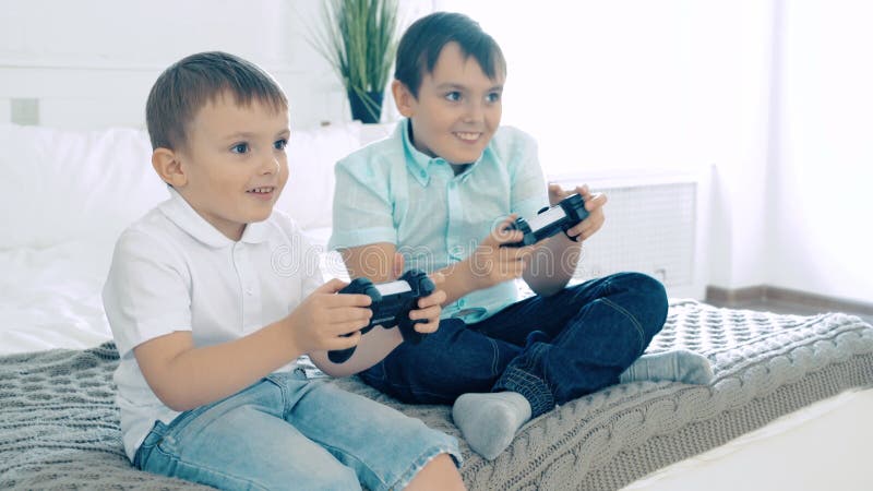 Two Friends or Brothers Smiling and Having Fun Playing a Video Game ...