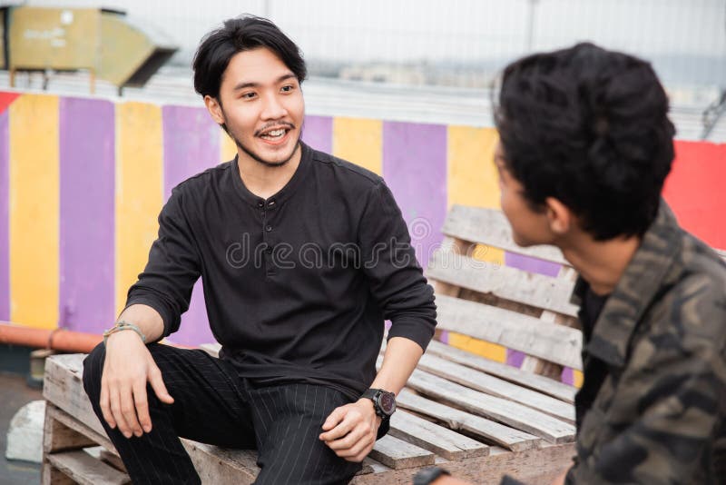 Two Friends Chatting Sitting on the Wooden Chair Stock Image - Image of ...