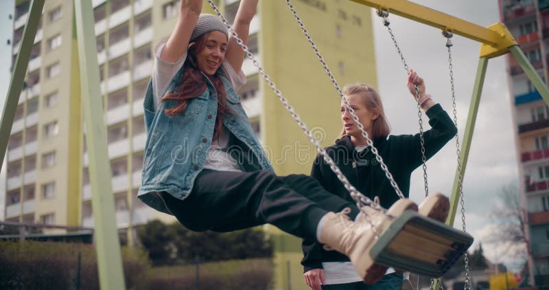 Two Friends, in a Chilly Mood, Swing Thoughtfully on a Swing at the ...