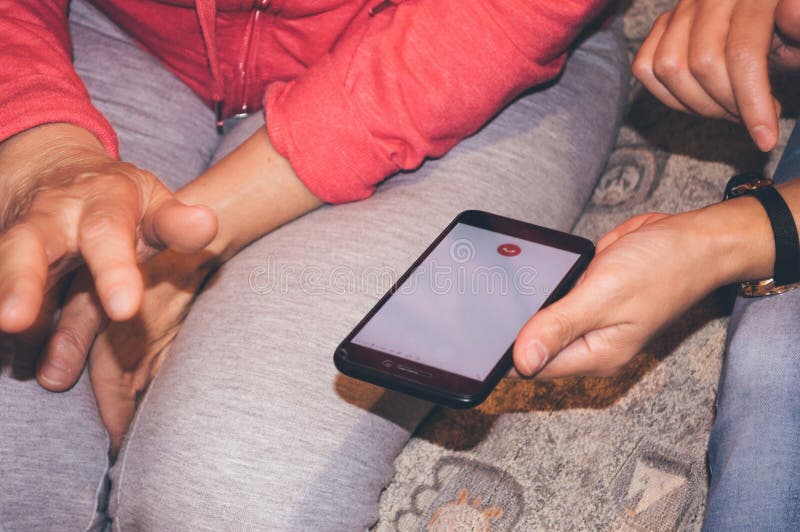 Two Friends Communicate, Holding Smartphone in Hands Stock Photo ...