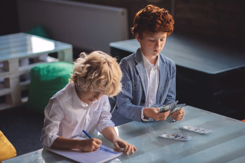 Two Friends Counting Saved Money and Looking Involved Stock Photo ...