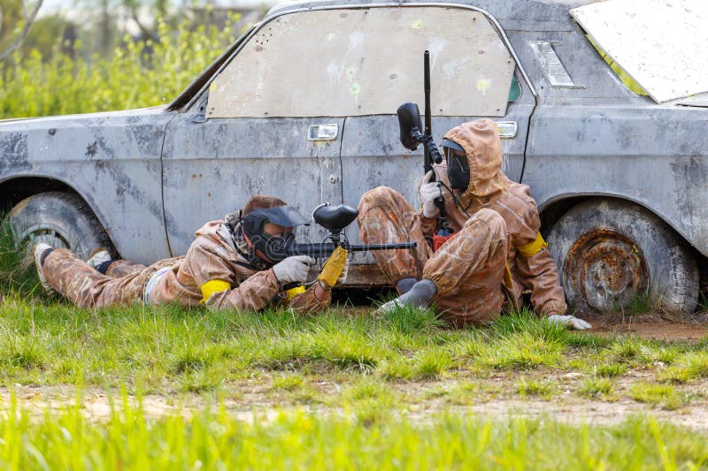 Two Friends Defend Old Car in Paintball Mission Stock Image - Image of ...